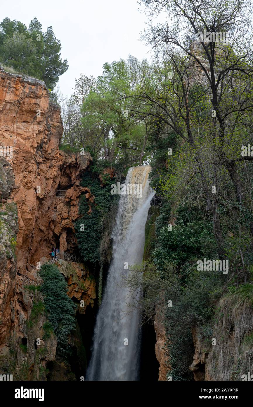 Lush greenery frames the powerful cascade at Monasterio de Piedra, a ...