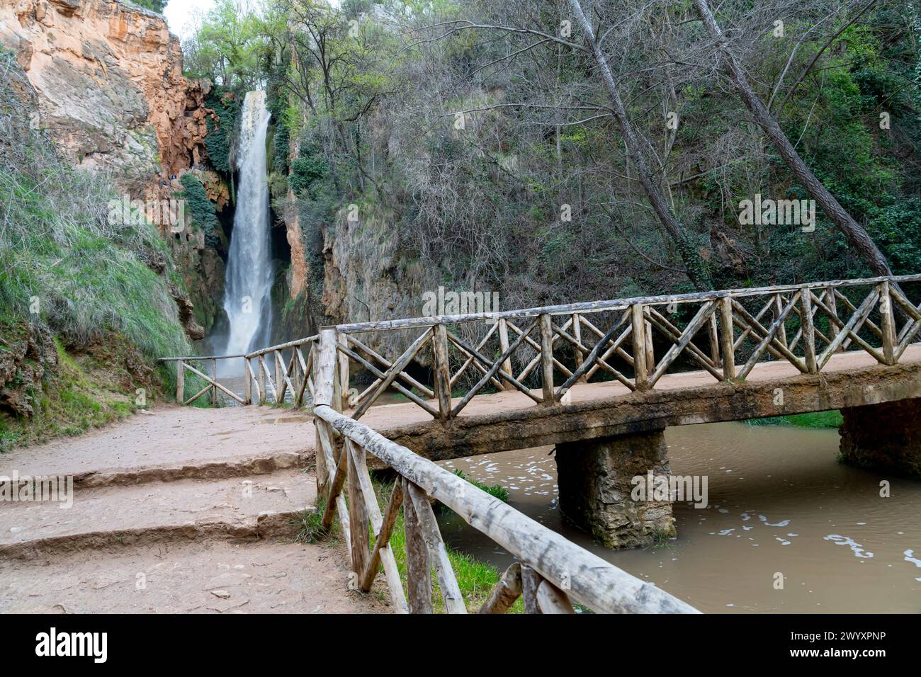 Lush greenery frames the powerful cascade at Monasterio de Piedra, a ...