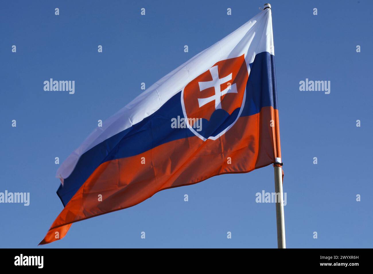 The national flag of Slovakia featuring white, blue, and red stripes ...