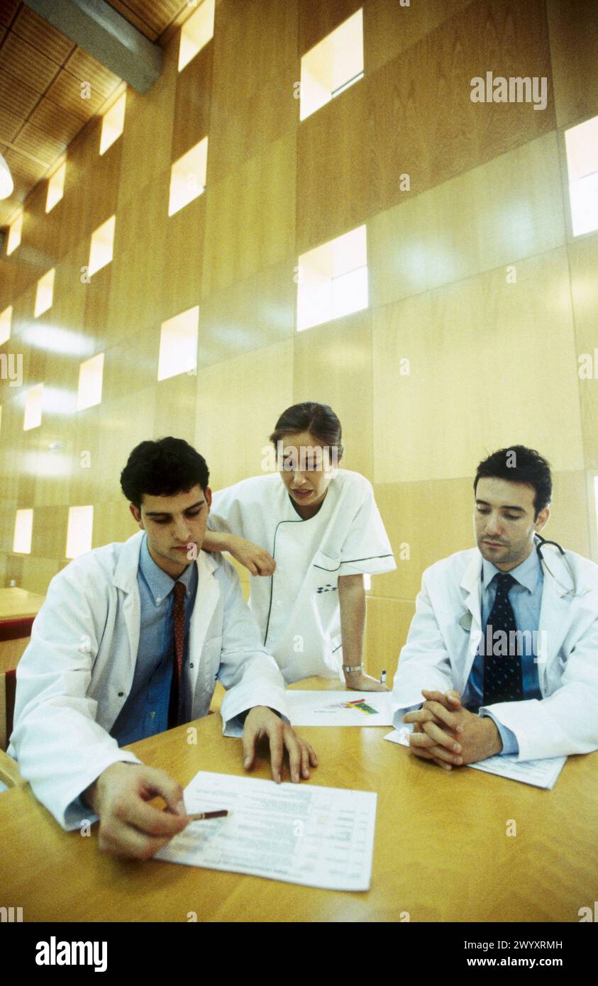 Meeting of doctors at library of hospital Stock Photo - Alamy