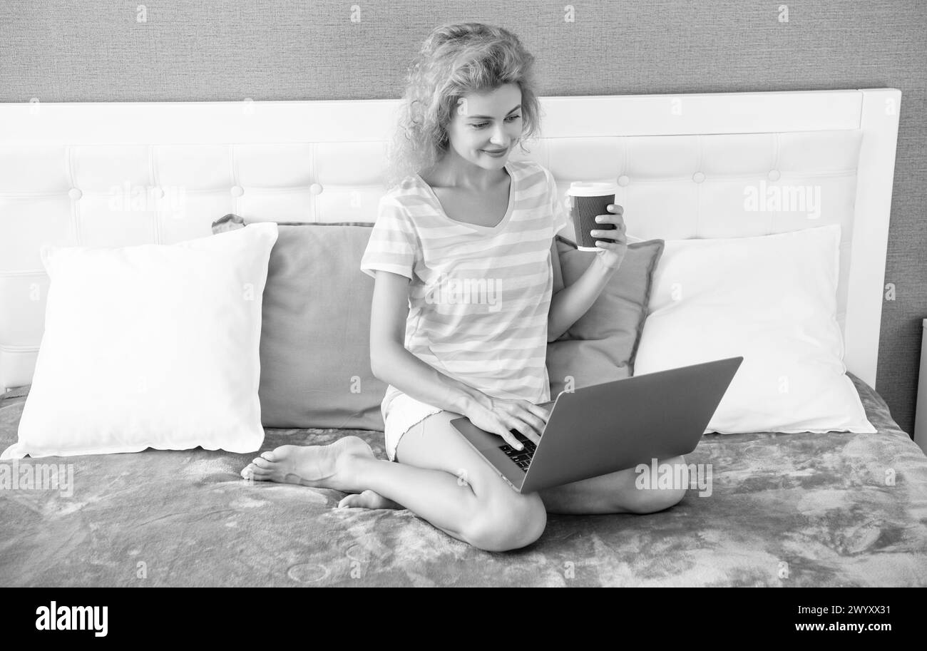 smiling woman freelancer with coffee blogging on laptop. freelancer ...