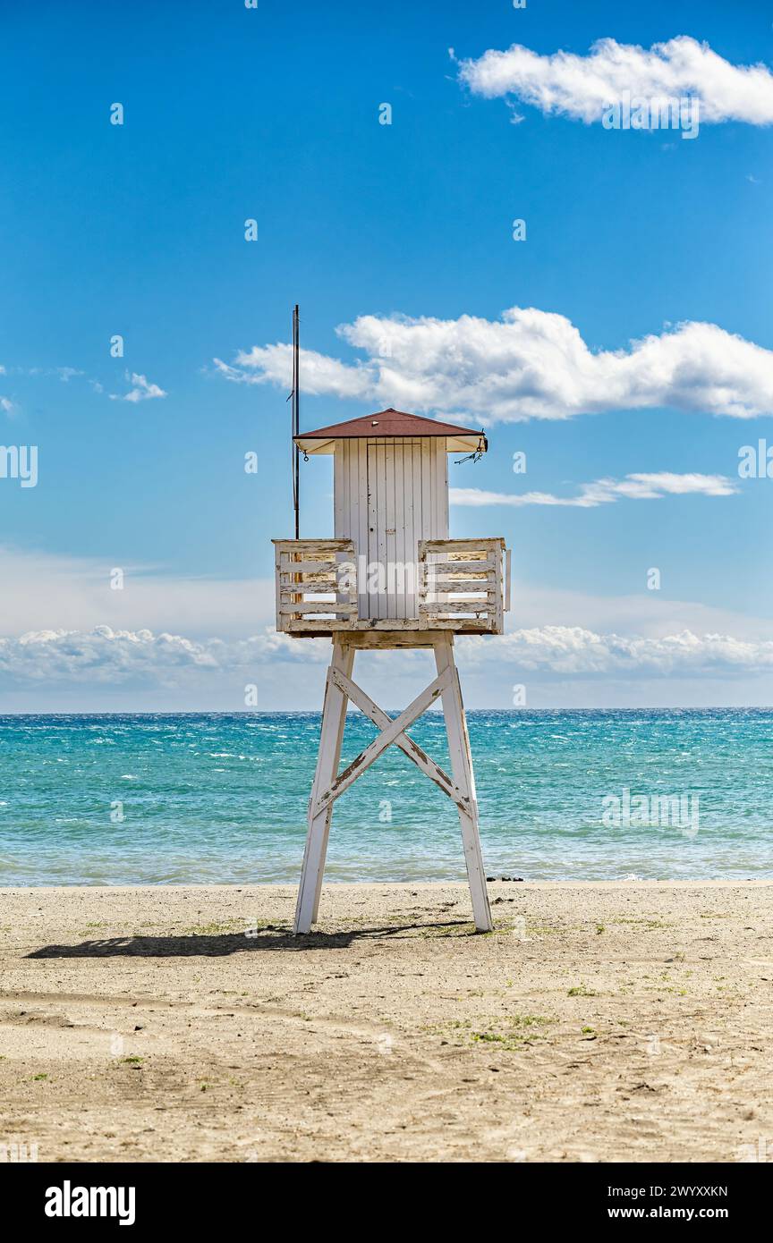 Lifeguard tower on the beach on a day with calm sea and blue sky with ...
