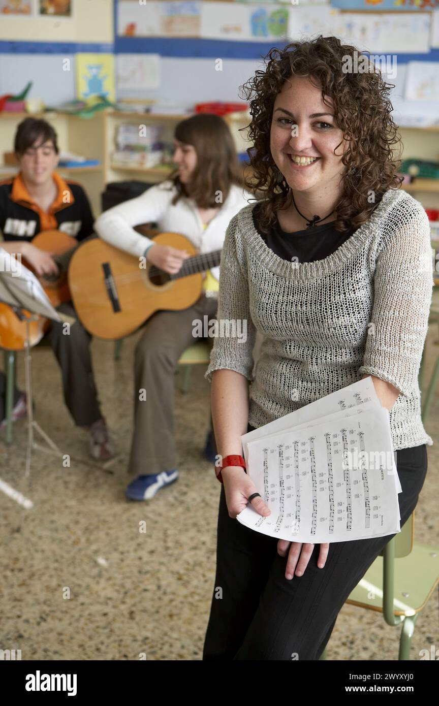 Music teacher, guitar instruction Stock Photo - Alamy