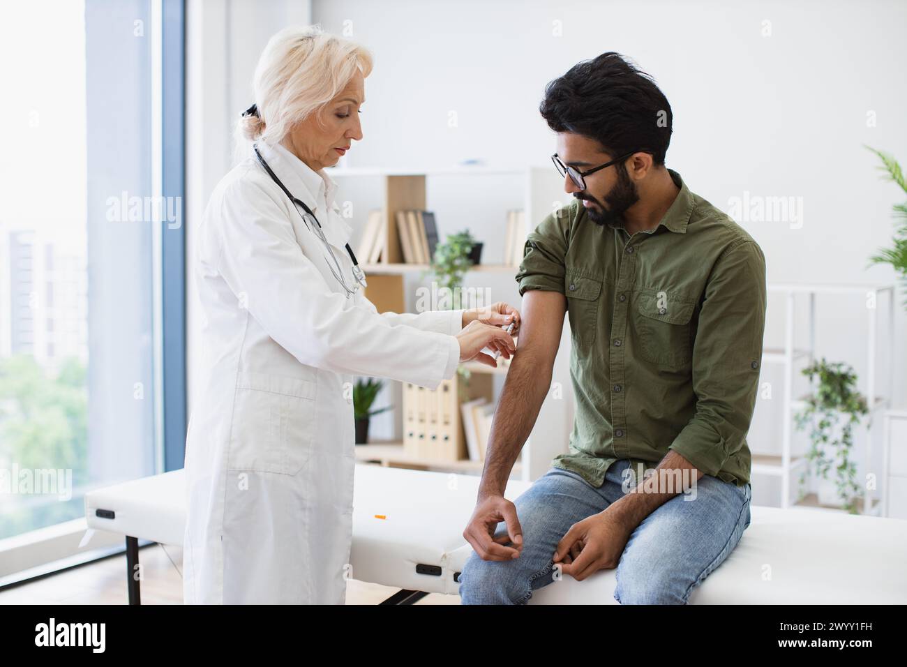 General practitioner giving injection to boost immunity for young ...