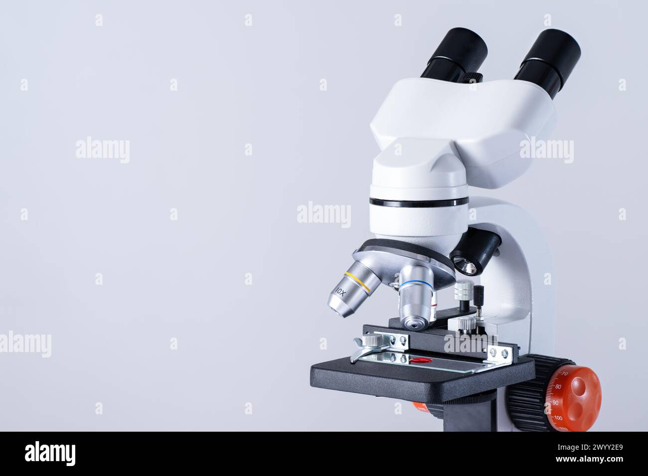 Microscope on white background with copy space. Blood sample on a glass ...