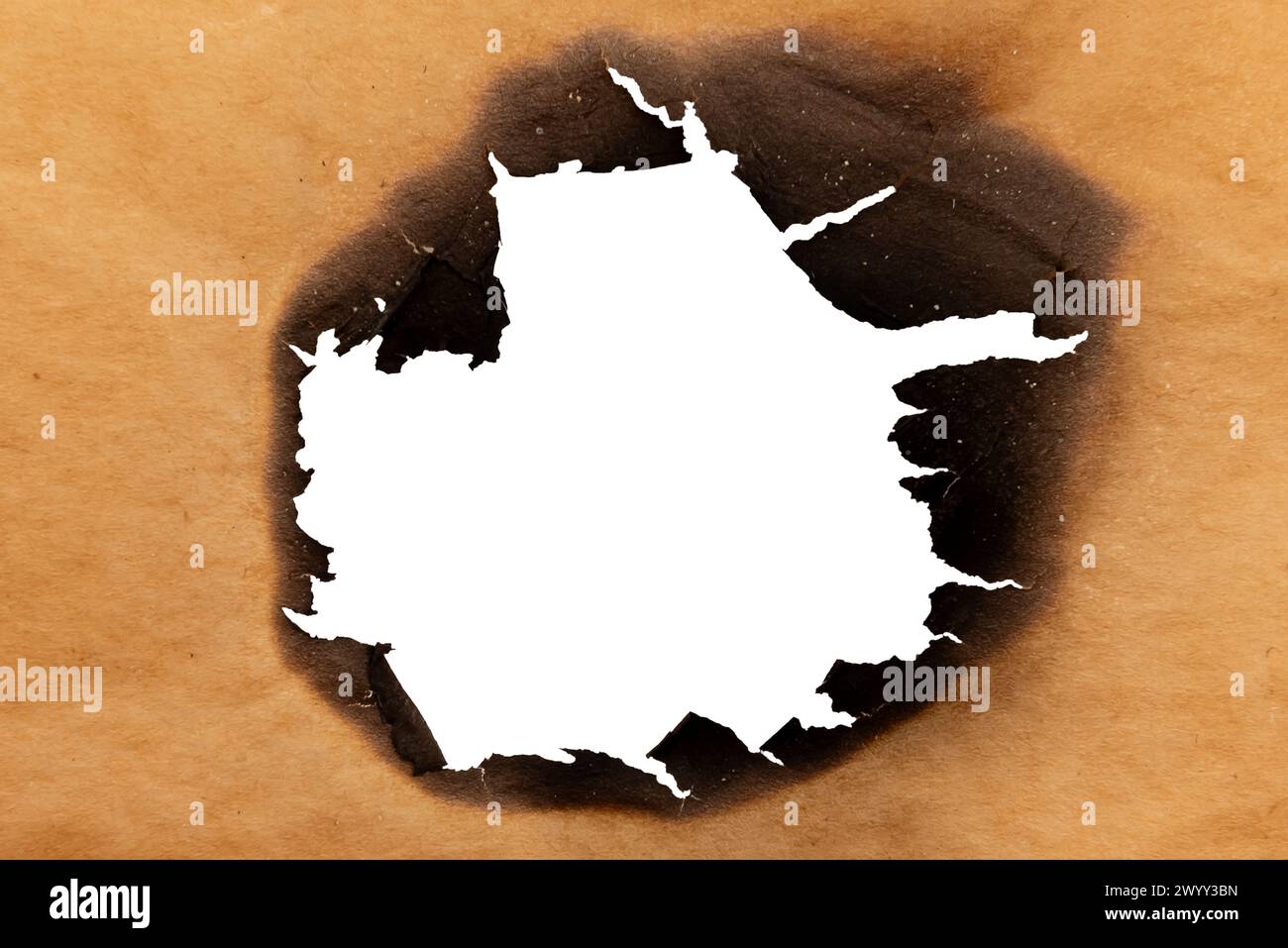 Burnt hole in yellow paper. Burnt paper Stock Photo - Alamy