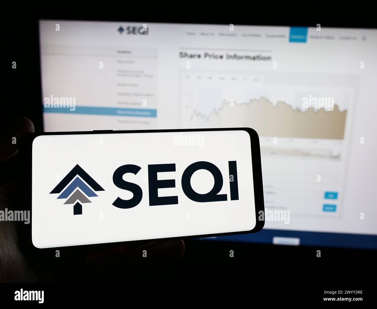 Person holding mobile phone with logo of Sequoia Economic ...