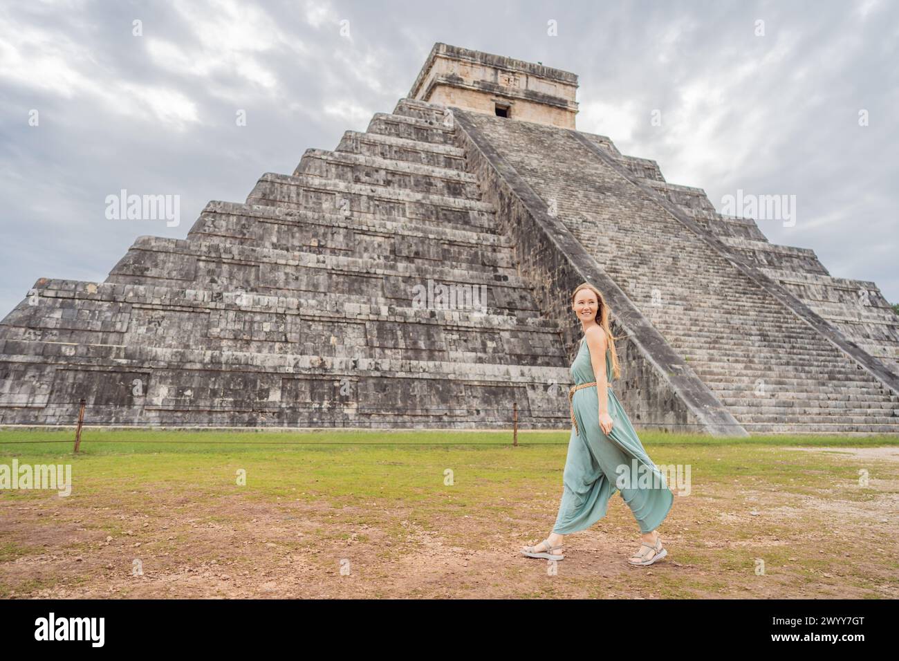 Beautiful tourist woman observing the old pyramid and temple of the ...