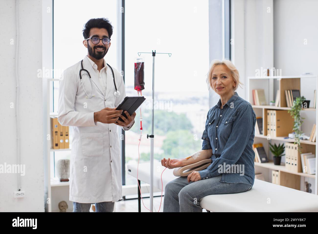 Healthcare practitioner consulting female patient with cancer in clinic ...
