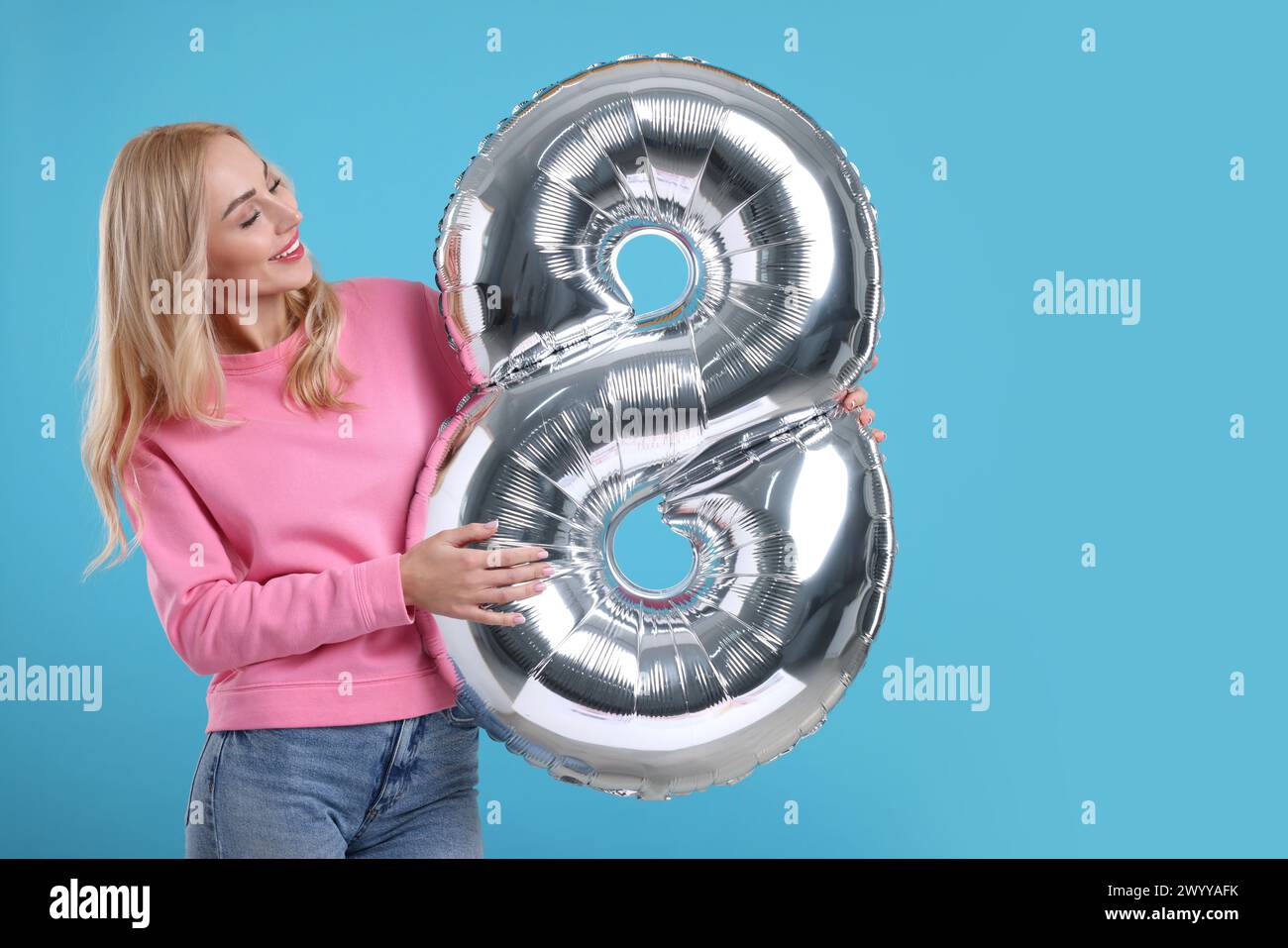 Happy Women's Day. Charming lady holding balloon in shape of number 8 ...