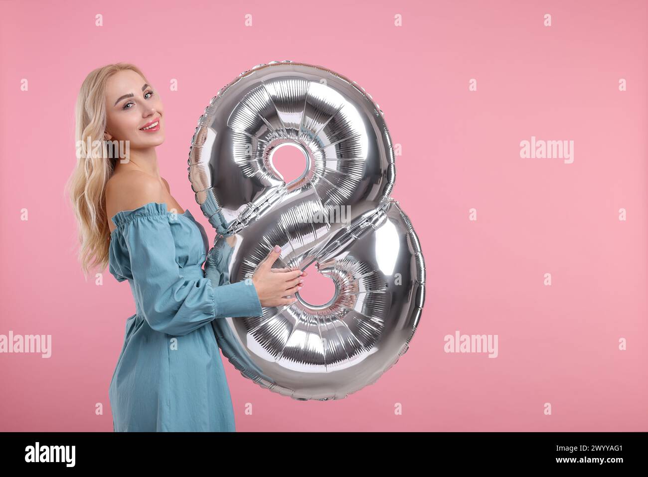Happy Women's Day. Charming lady holding balloon in shape of number 8 ...