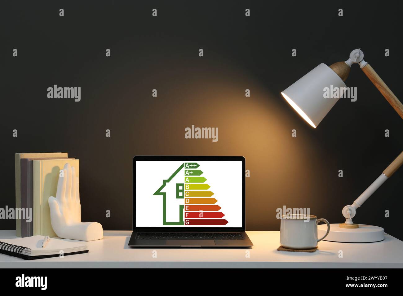 Energy efficiency rating on laptop display. Workplace with modern ...
