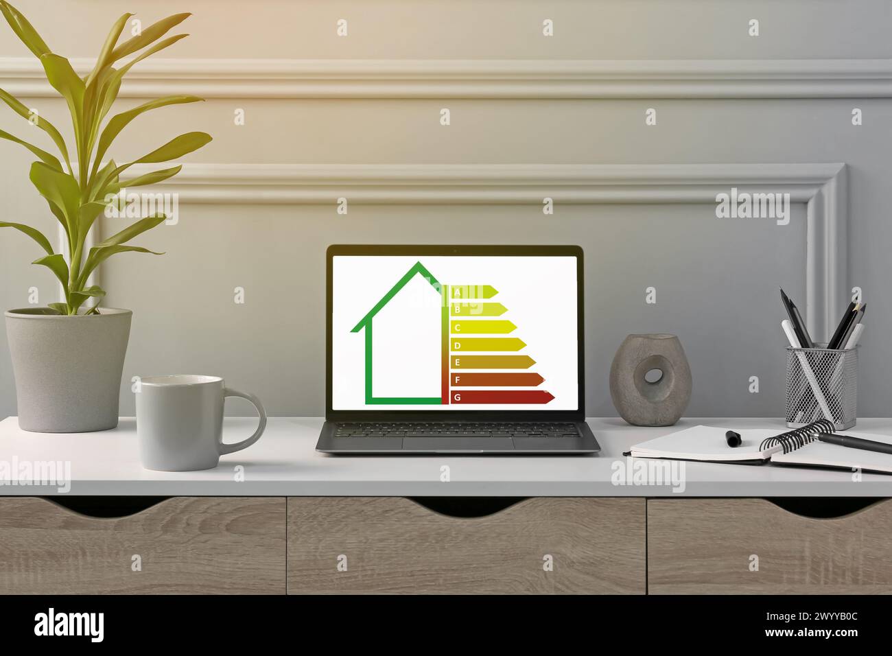 Energy efficiency rating on laptop display. Workplace with modern ...