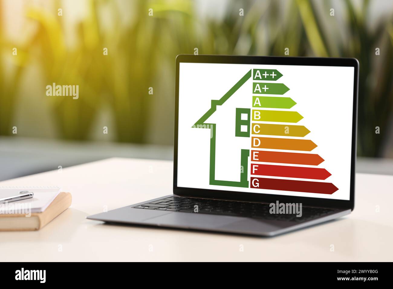 Energy efficiency rating on laptop display. Workplace with modern ...