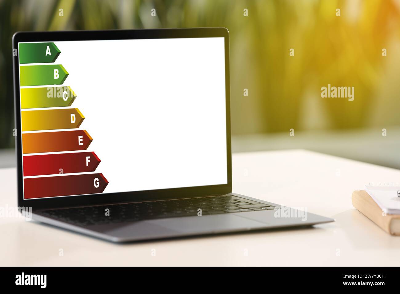 Energy efficiency rating on laptop display. Workplace with modern ...