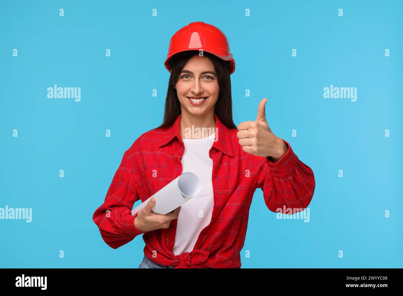 Architect in hard hat with draft on light blue background Stock Photo ...