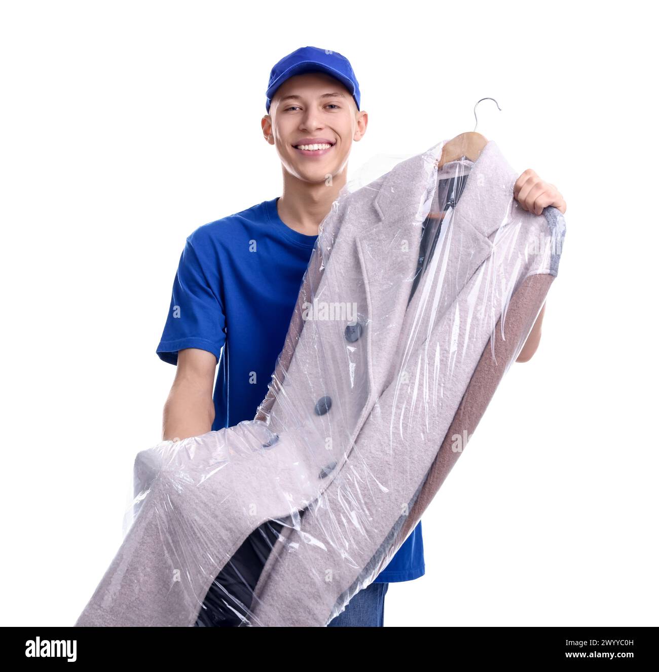 Dry-cleaning delivery. Happy courier holding coat in plastic bag on ...
