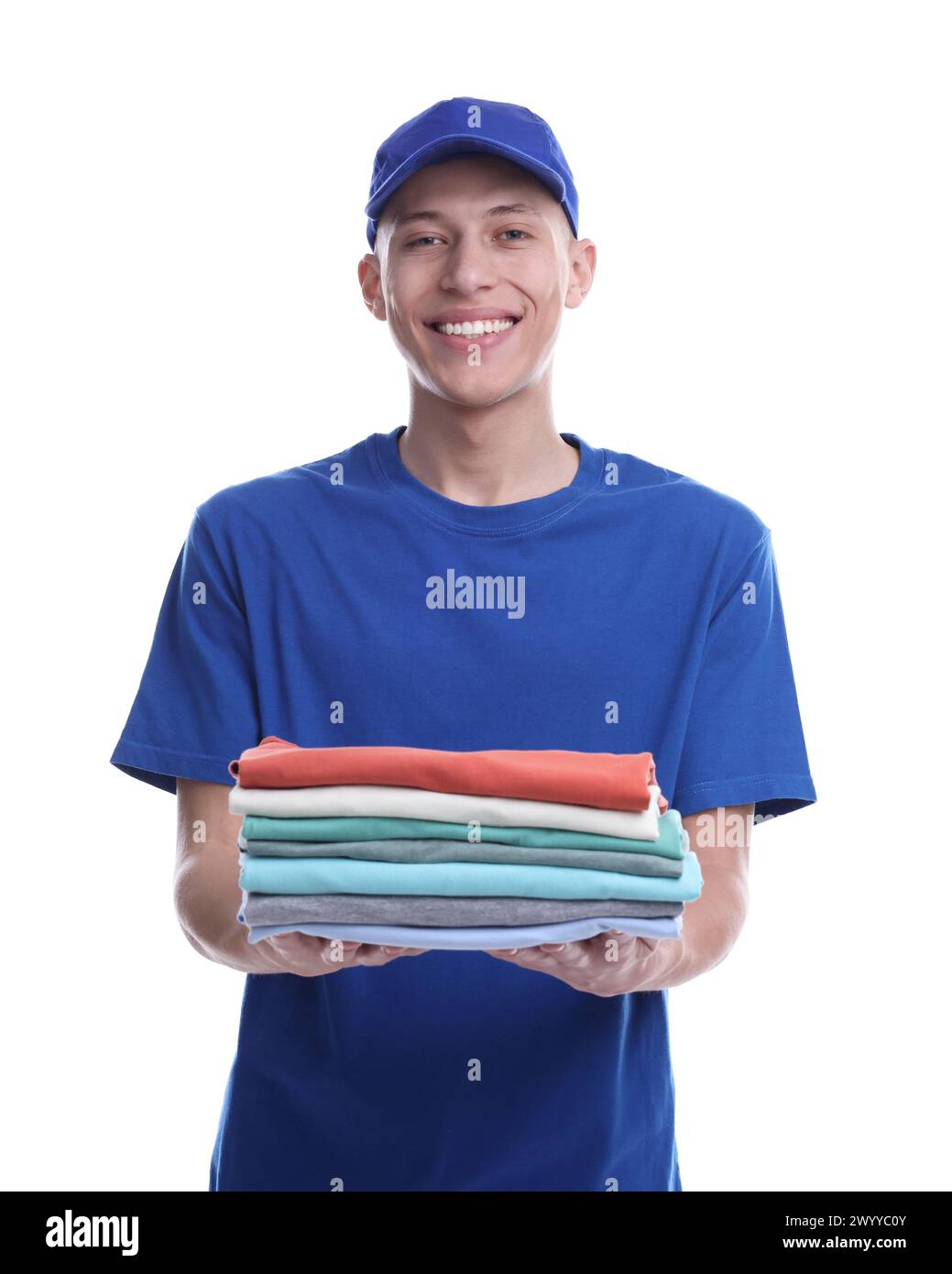 Dry-cleaning delivery. Happy courier holding folded clothes on white ...