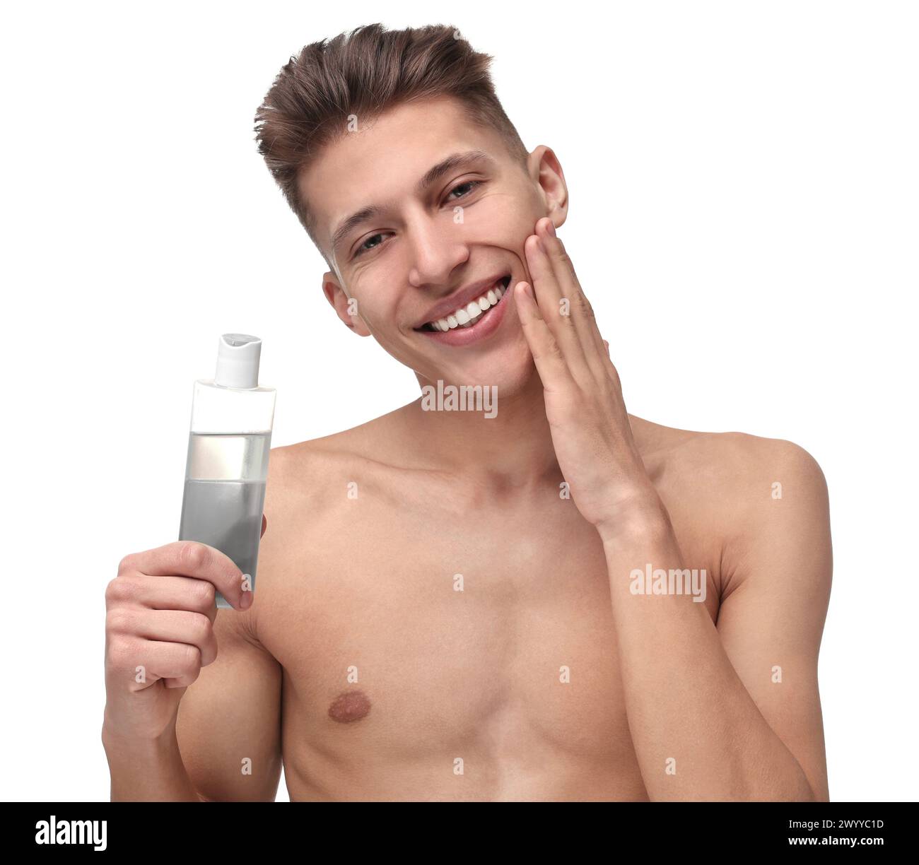 Handsome man applying lotion onto his face on white background Stock Photo - Alamy