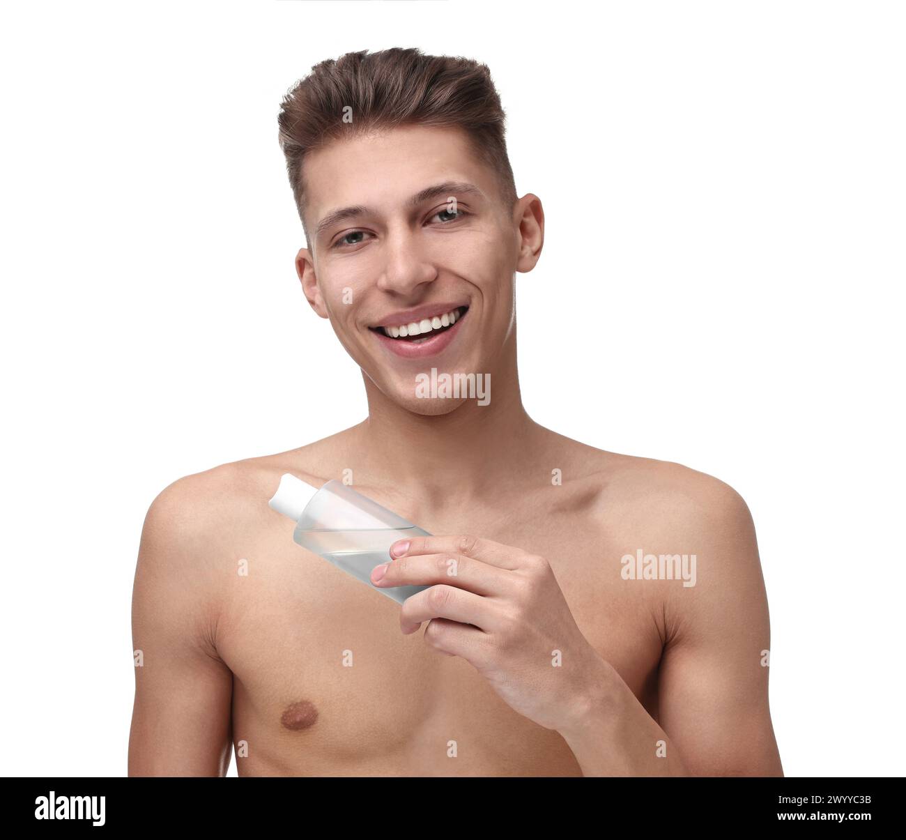 Handsome man applying lotion onto his body on white background Stock Photo - Alamy