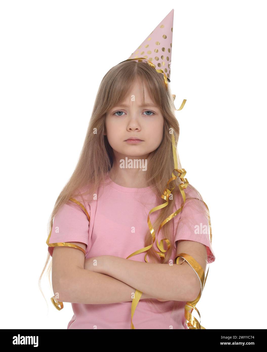 Unhappy little girl in party hat with crossed arms on white background ...