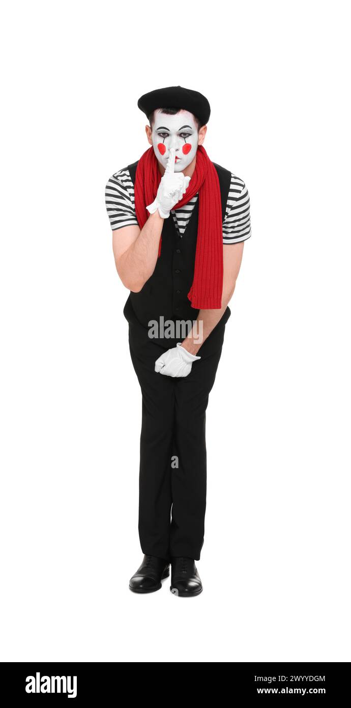 Funny mime artist in beret showing hush gesture on white background ...