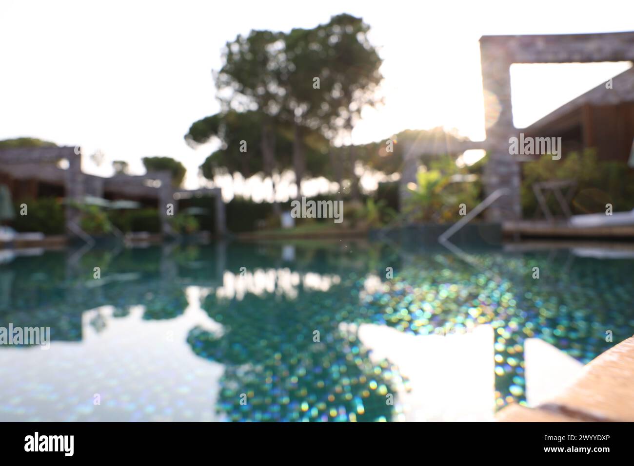 Outdoor swimming pool at resort, blurred view Stock Photo - Alamy
