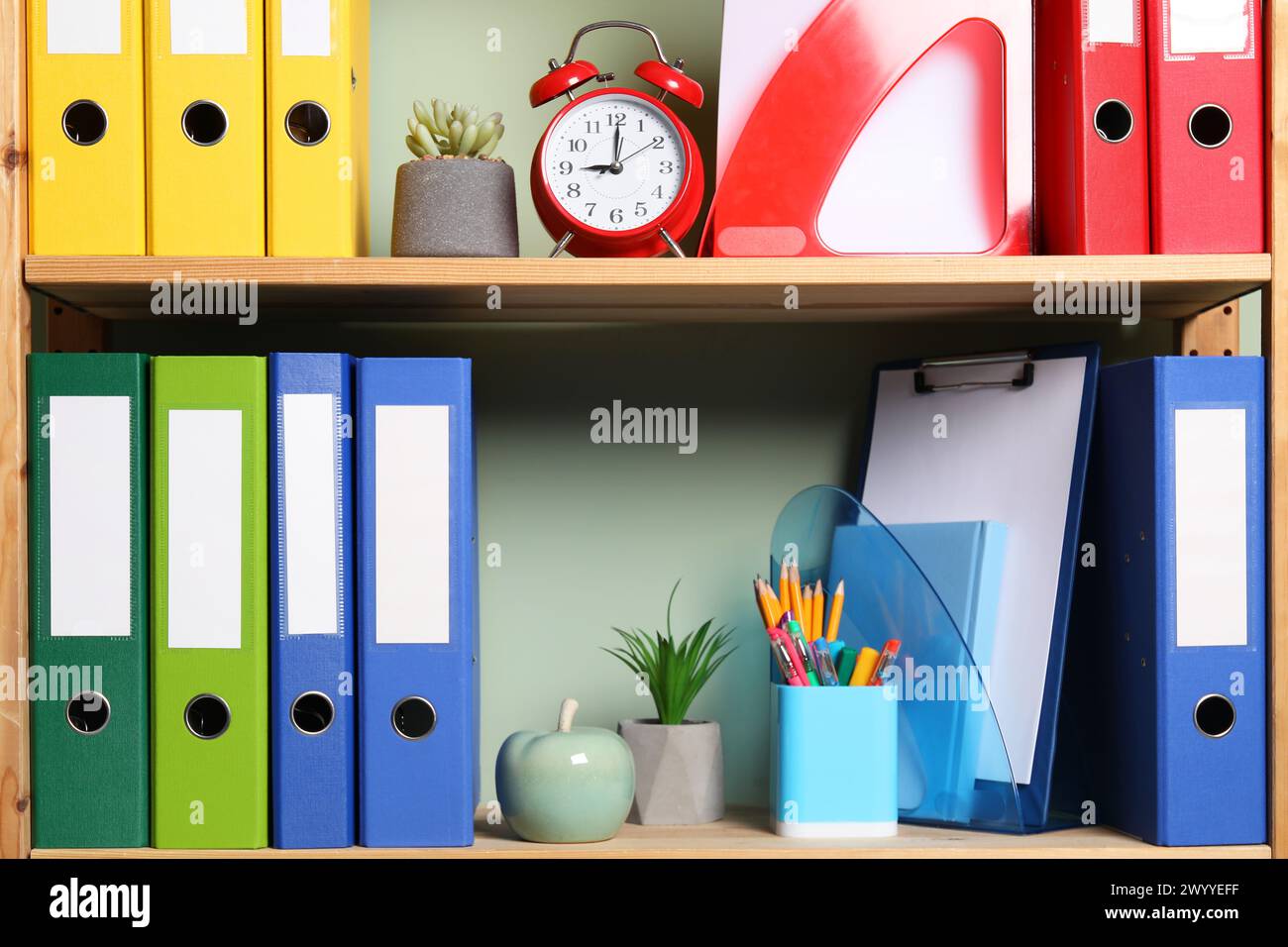 Colorful binder office folders and stationery on shelving unit indoors ...