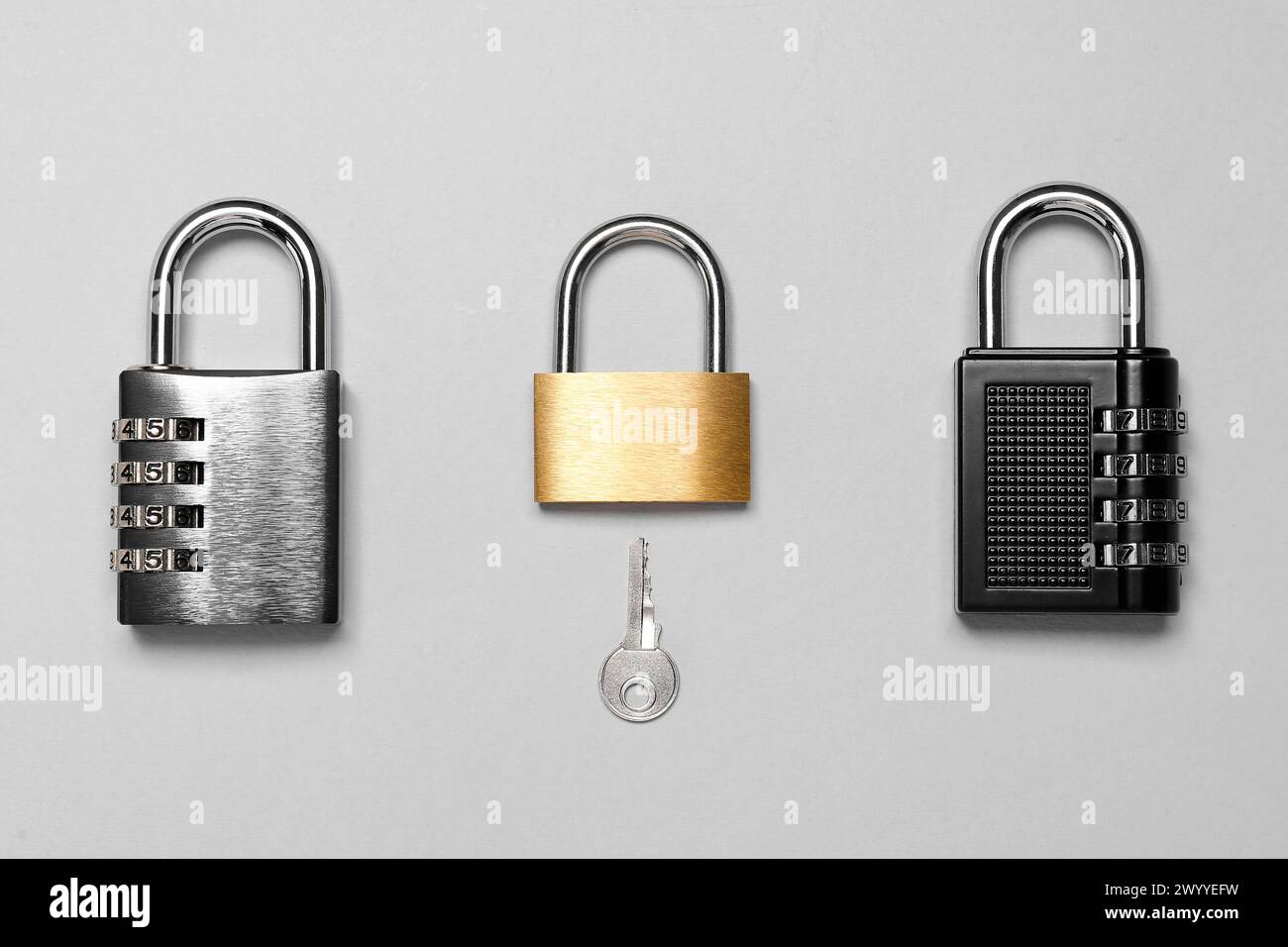 Different padlocks and key on grey background, flat lay Stock Photo - Alamy