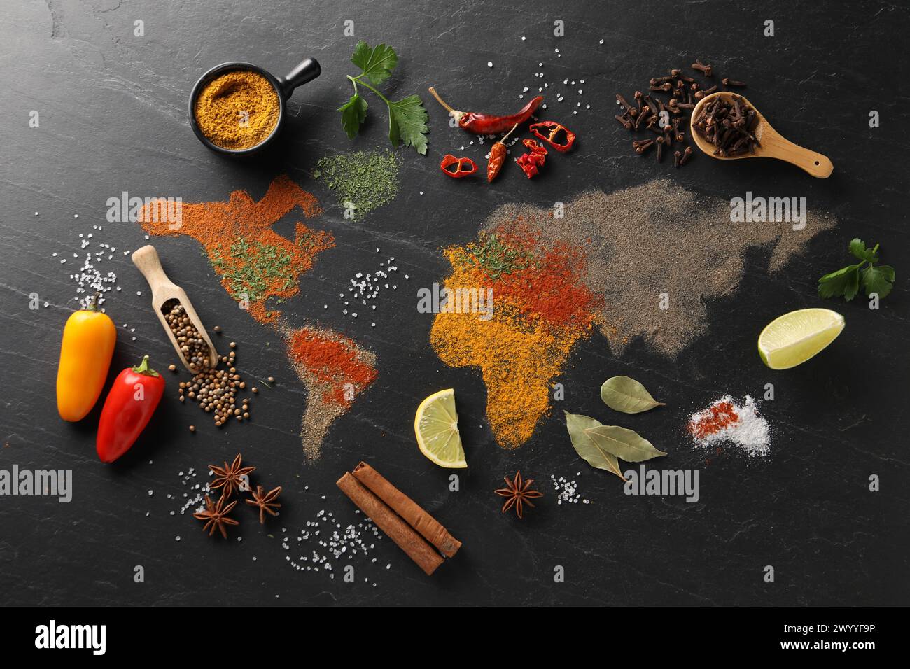 World map of different spices and products on dark textured table, flat ...