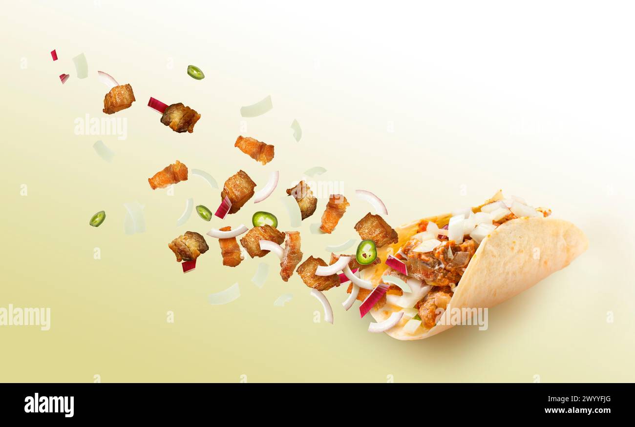 Delicious taco with flying ingredients on color gradient background Stock Photo - Alamy