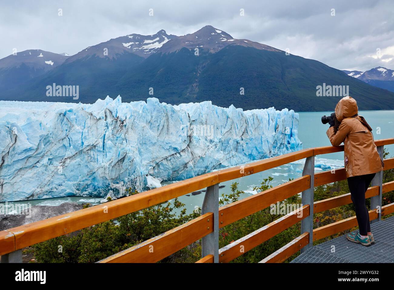 Tourist taking pictures. Mini trekking. Walk on the glacier with ...