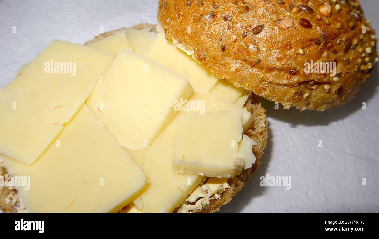 Crusty seeded brown roll with layers of cheese on Stock Photo - Alamy