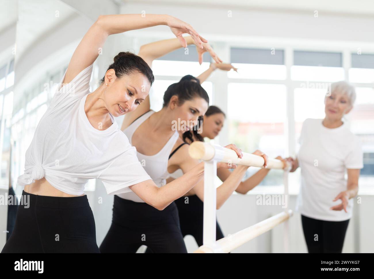 Experienced choreographer teaches ballet dancers movements at ballet ...