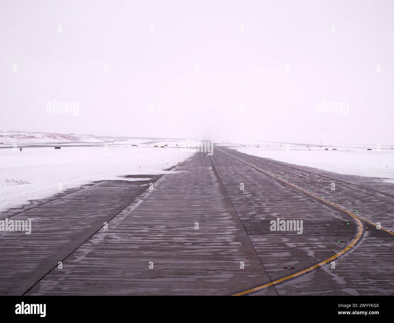 Airport runway in winter with snow, ice and meltwater over concrete ...