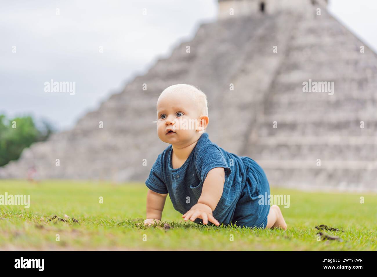 Baby traveler, tourists observing the old pyramid and temple of the ...