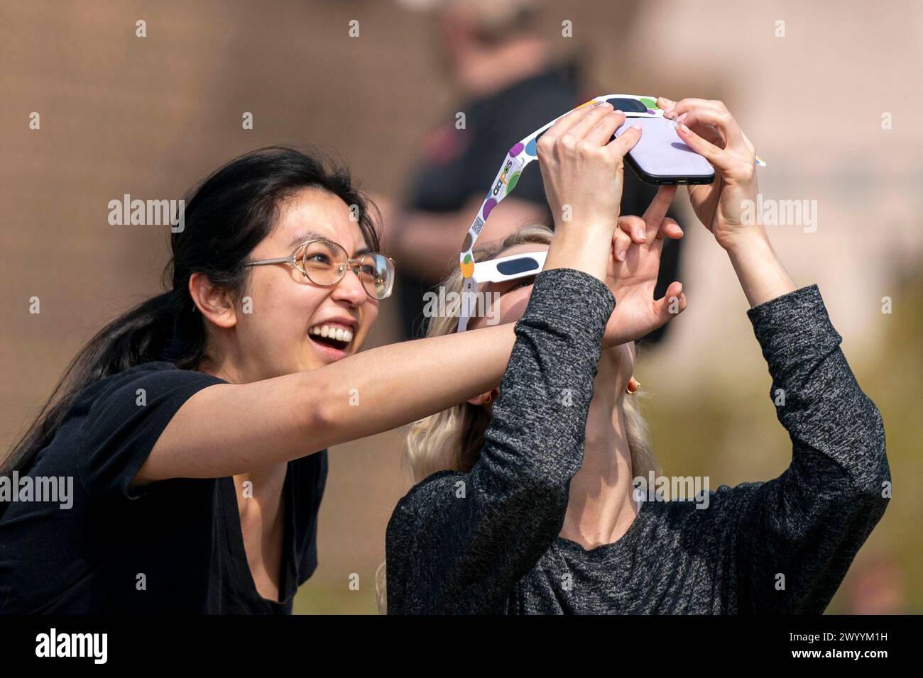 Washington, United States. 08th Apr, 2024. A woman helps a friend take ...