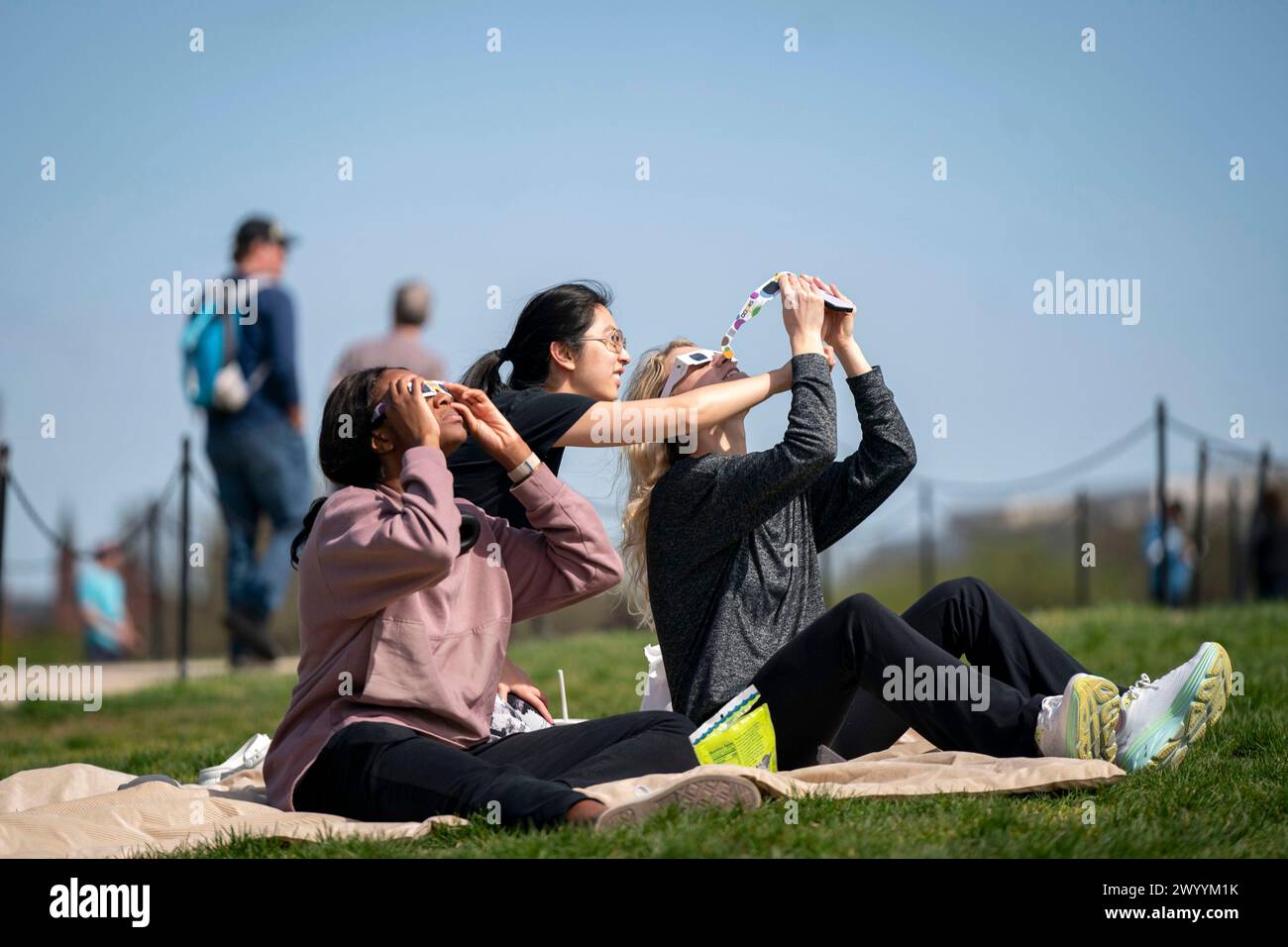 Washington, United States. 08th Apr, 2024. A woman helps a friend take ...