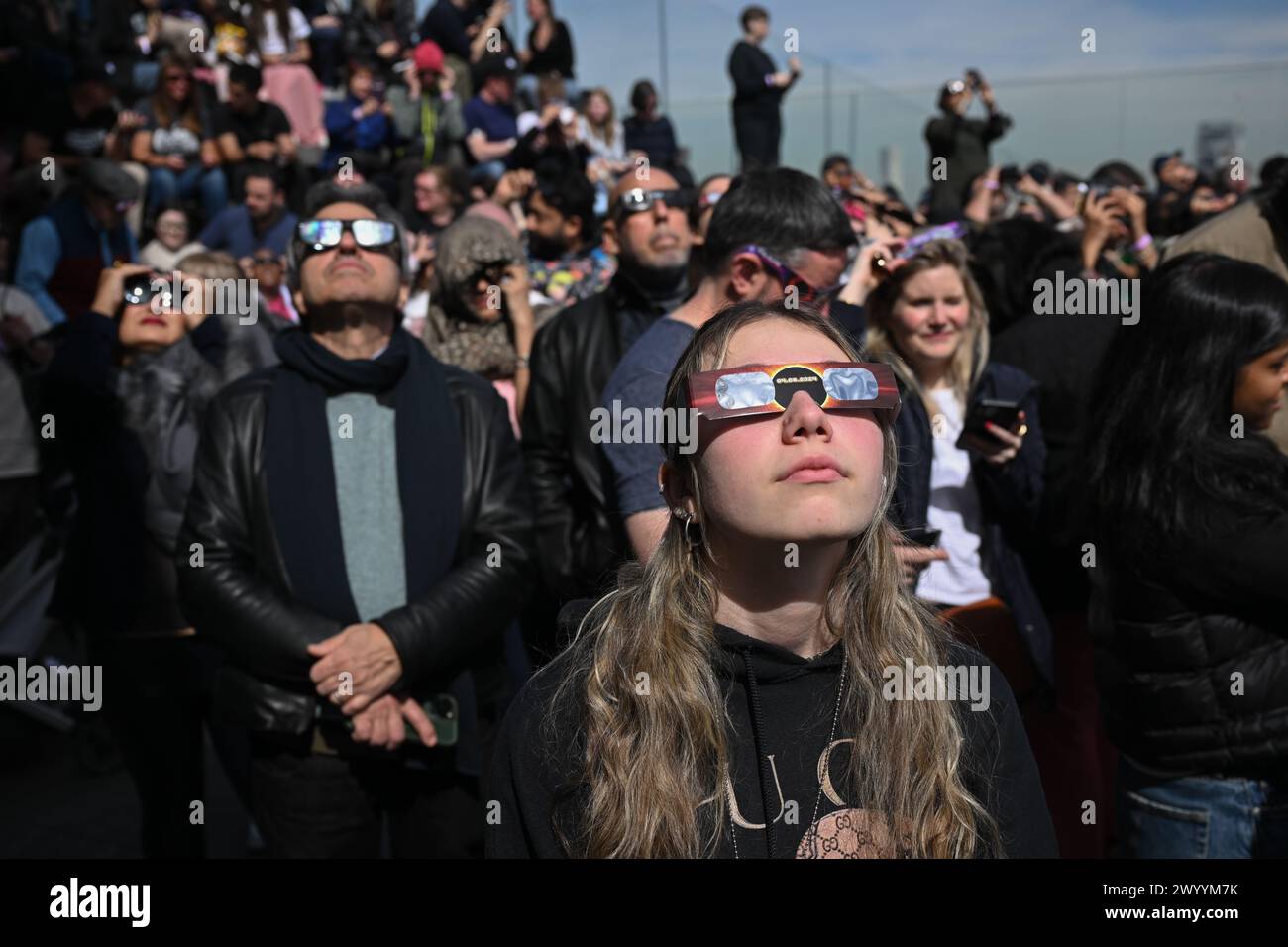 People gather at watch the Solar Eclipse at Edge Hudson Yards on April ...