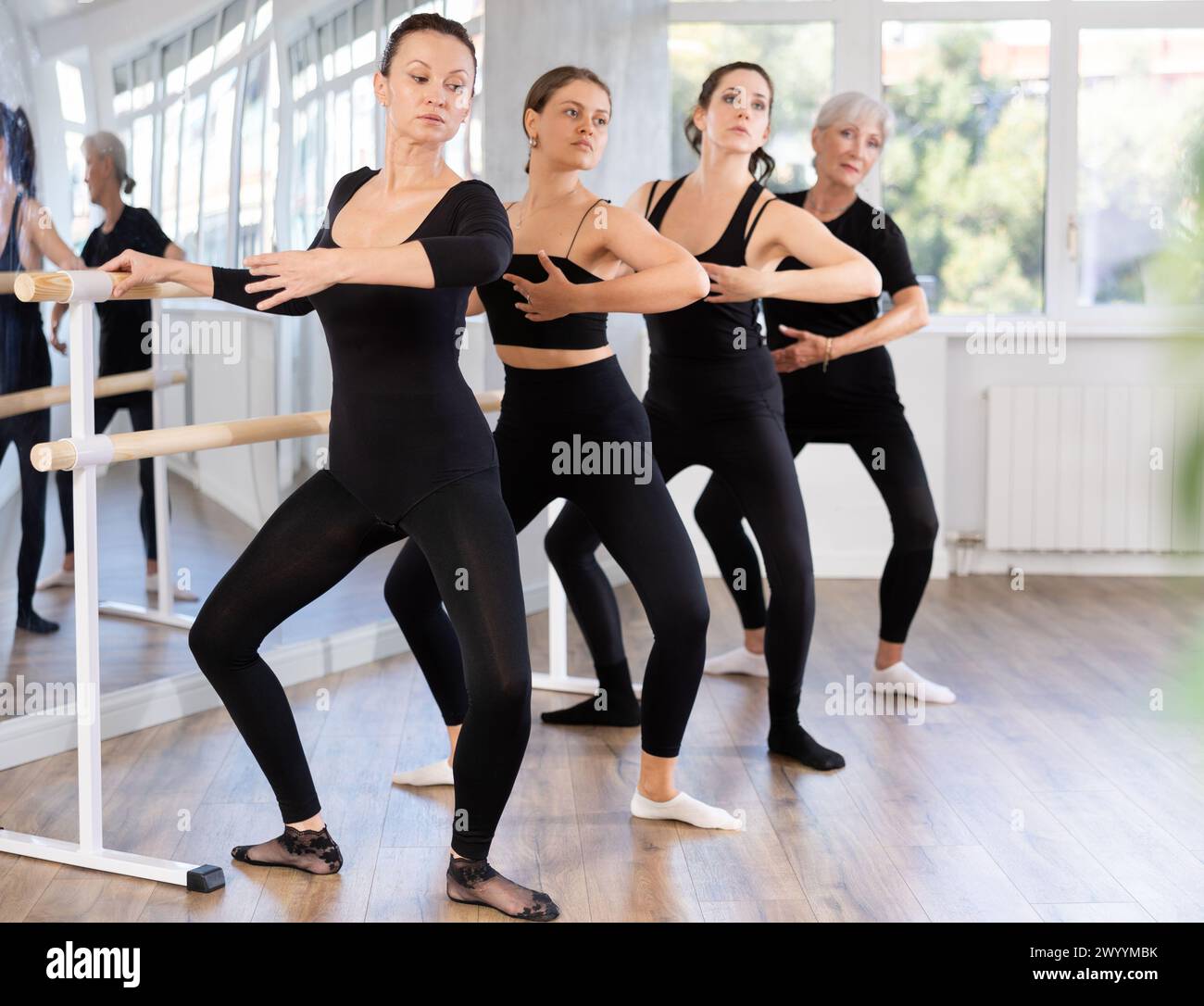Woman practicing demi plie hi-res stock photography and images - Alamy