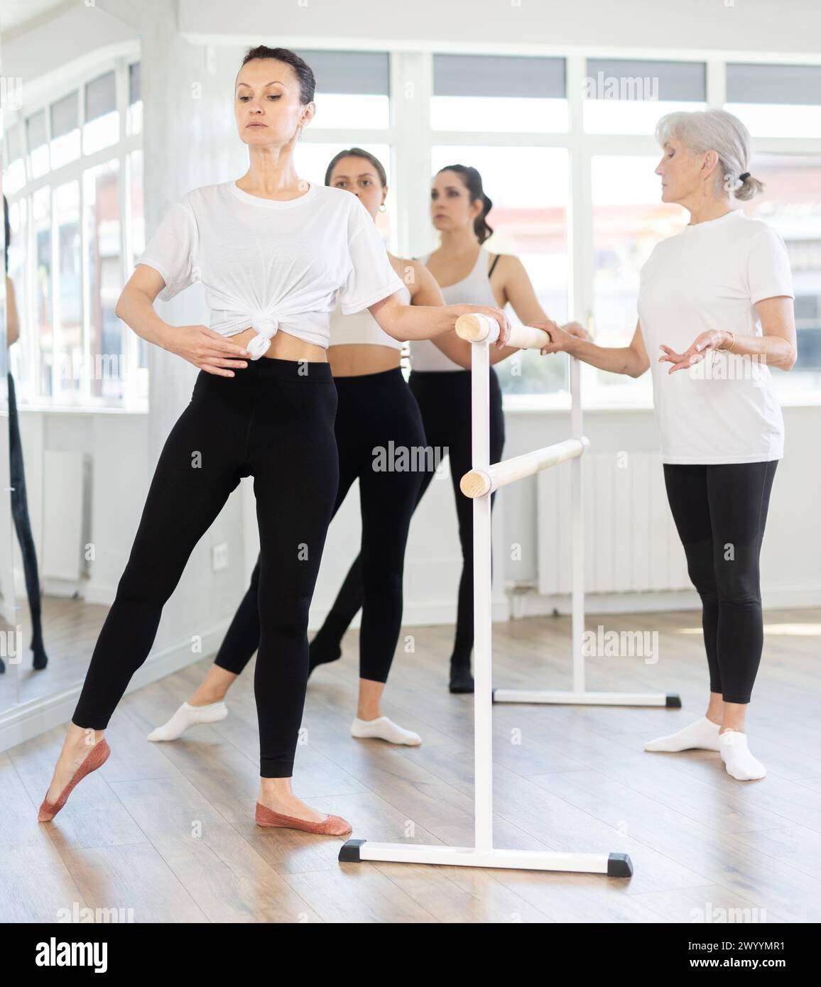 Group of ballet dancers learn new moves under the guidance of an ...