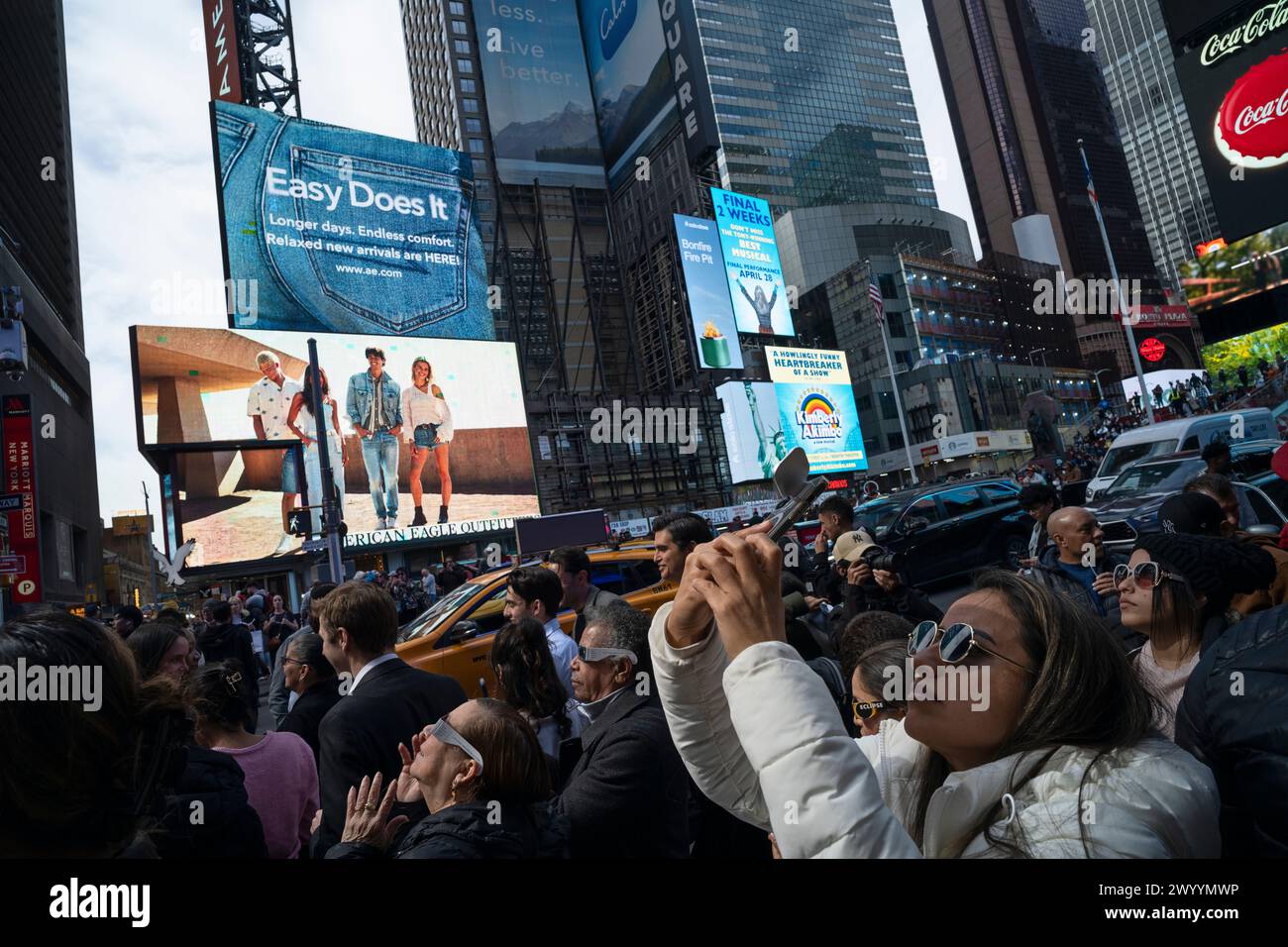 New York, New York, USA 8 April 2024 People in Times Square watch moon ...