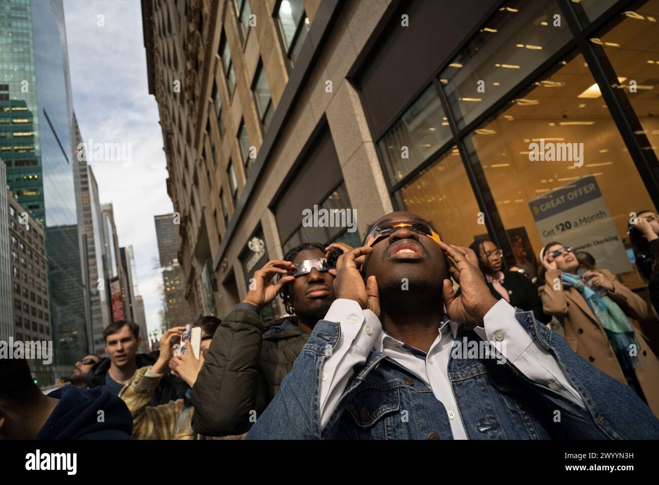 New York, New York, USA 8 April 2024 People in Midtown Manhattan watch ...