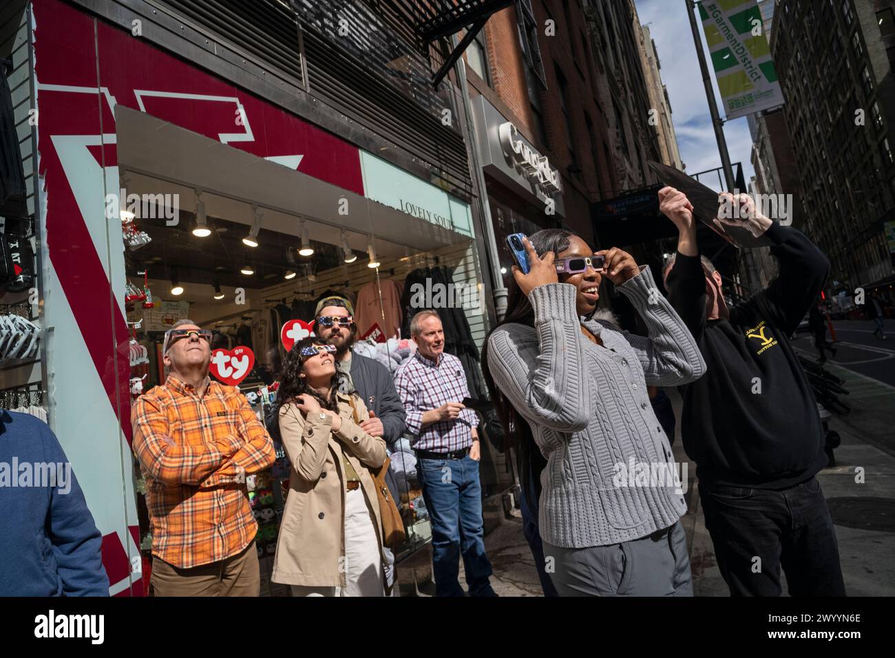 New York, New York, USA 8 April 2024 People in Midtown Manhattan watch ...