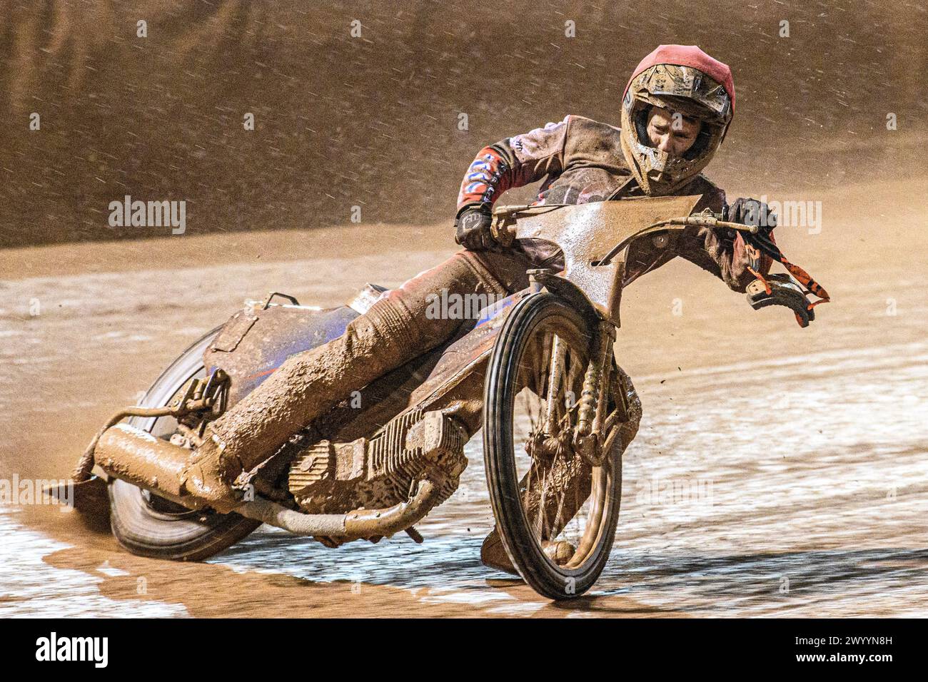 Ben Cook of Belle Vue Aces rides through the mud with his goggles on ...