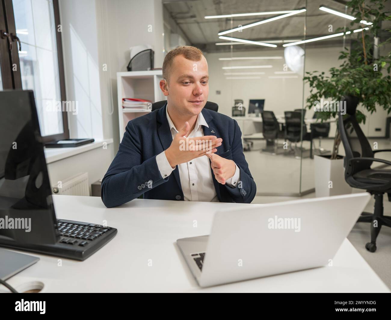 Caucasian deaf man talking sign language over video call on laptop in ...