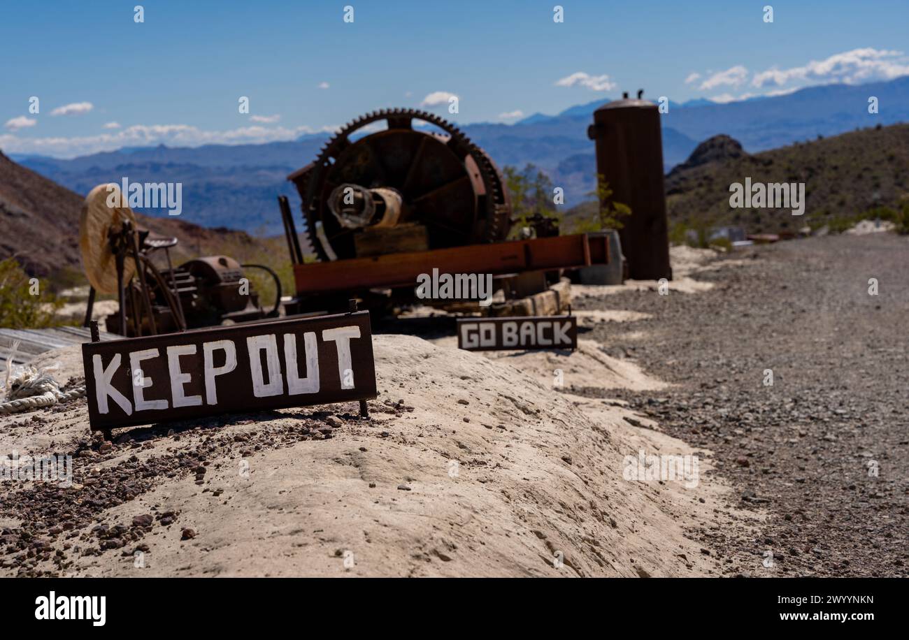 Keep out and go back signs posted in a dangerous area warning of ...