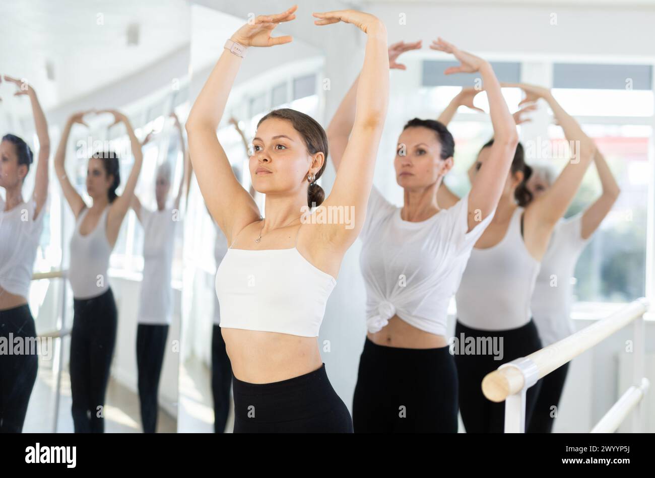 Girls in ballet class perform fifth position with participation of ...