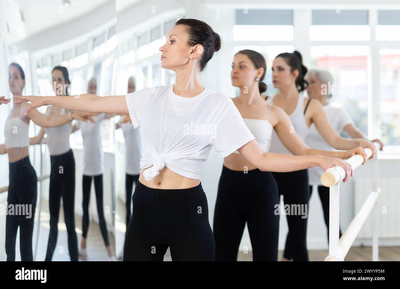 Group of women practicing at ballet barre Stock Photo - Alamy