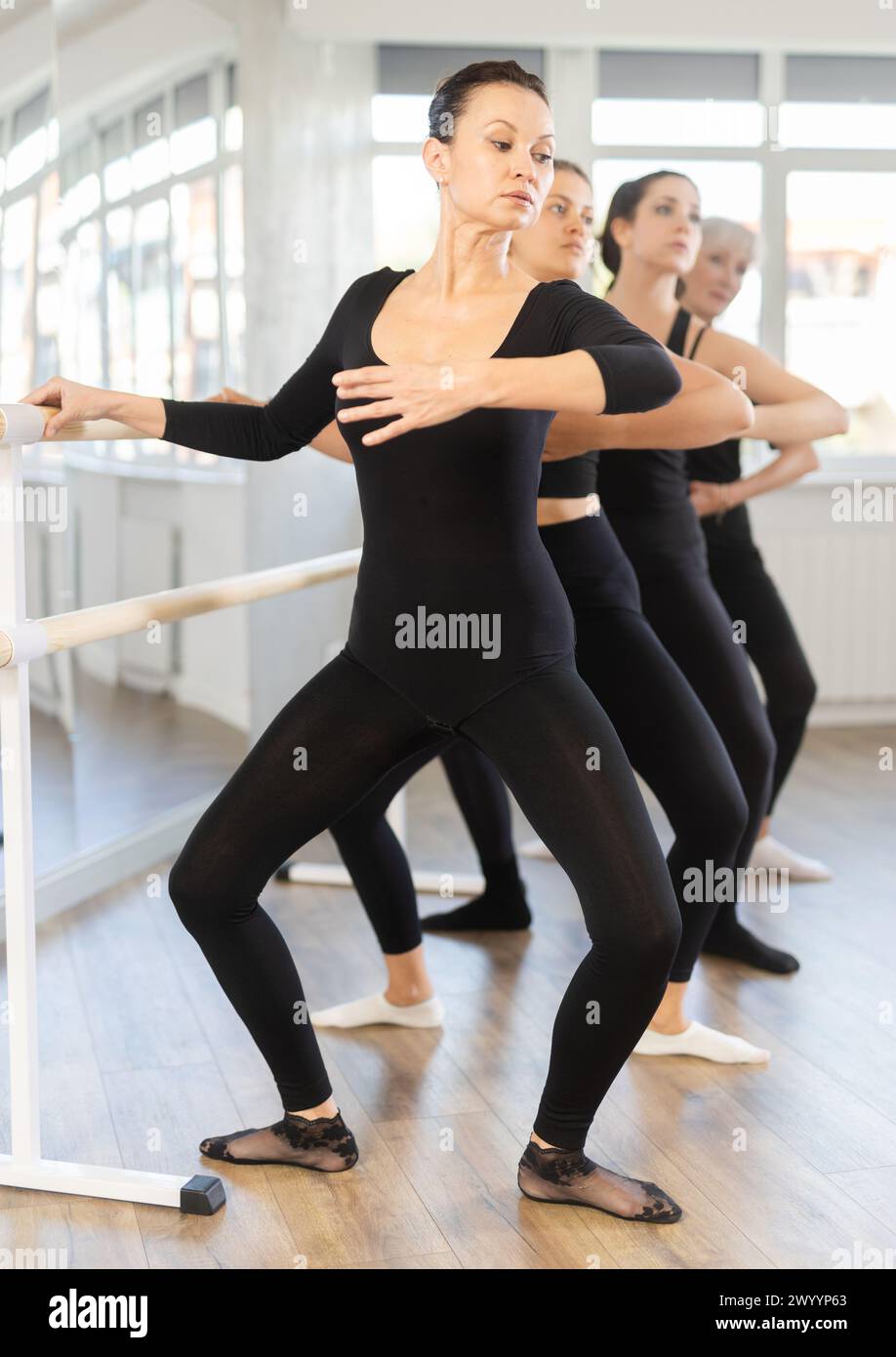 Woman practicing demi plie hi-res stock photography and images - Alamy